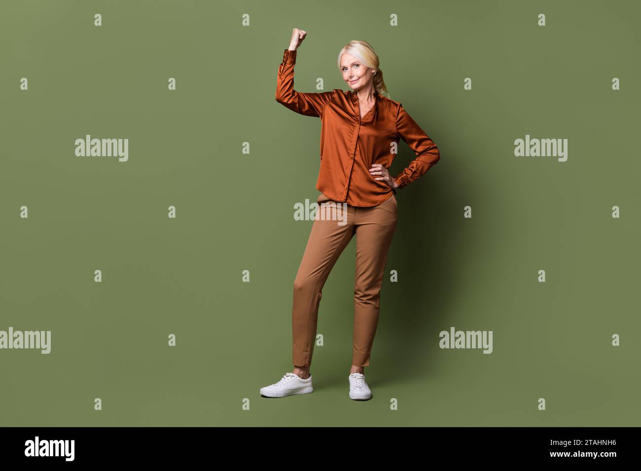 Mature woman flexing biceps hi-res stock photography and images - Alamy