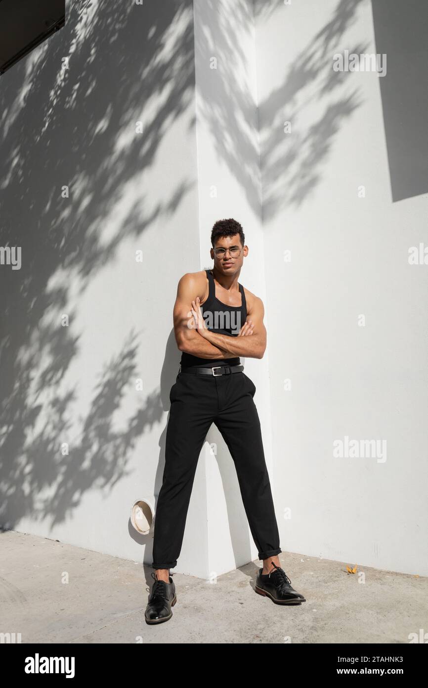 Full length of confident and muscular young cuban man in eyeglasses and ...