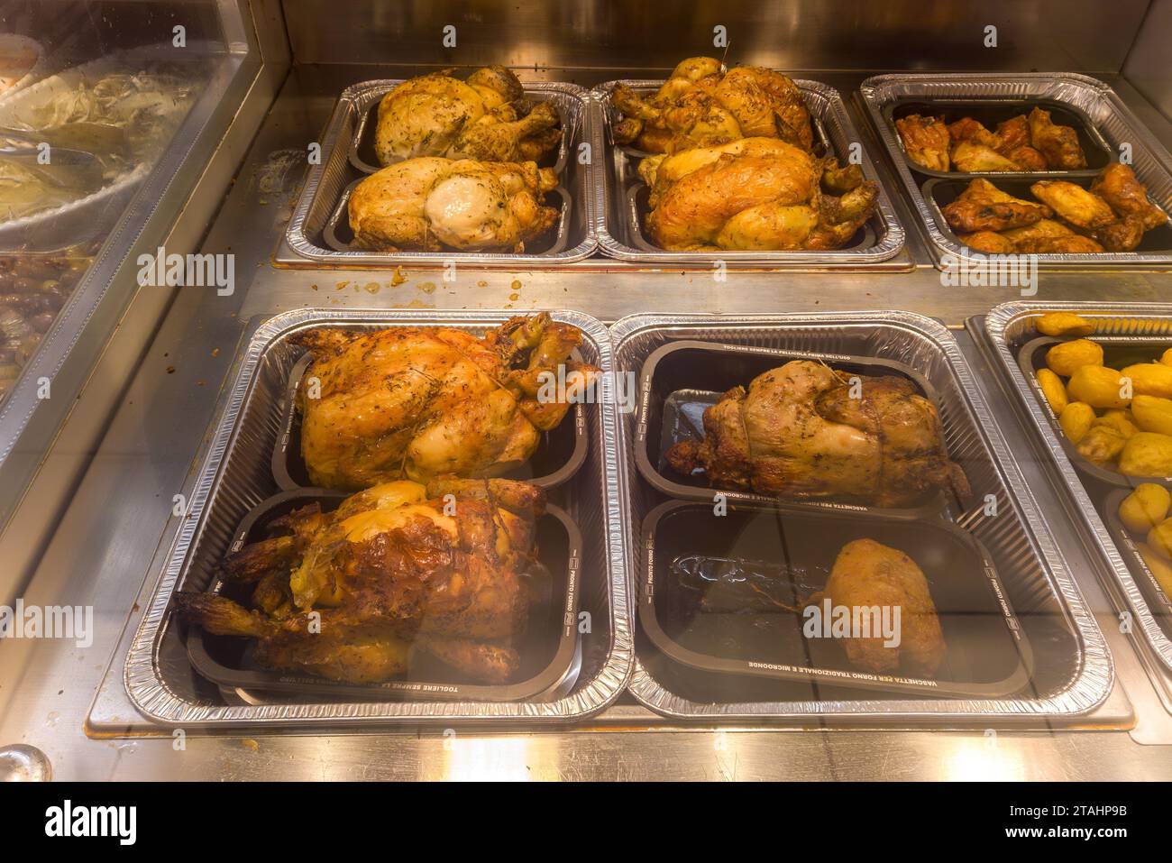 Italy - November 26, 2023: Spit-roasted chickens displayed in thermal ...