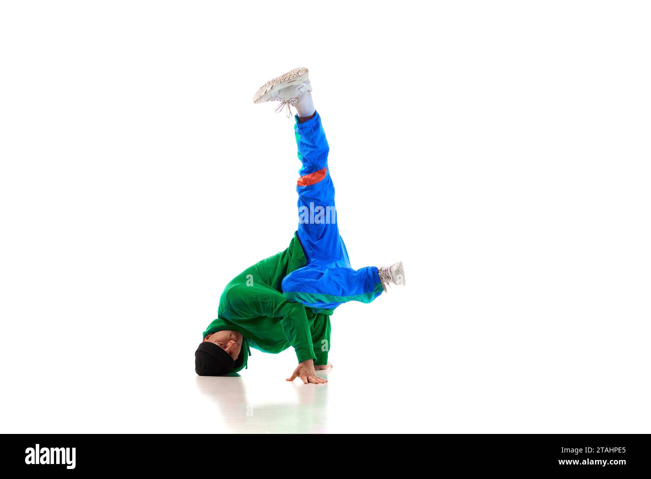 Young flexible sportive man dancing freestyle dance in green and blue ...