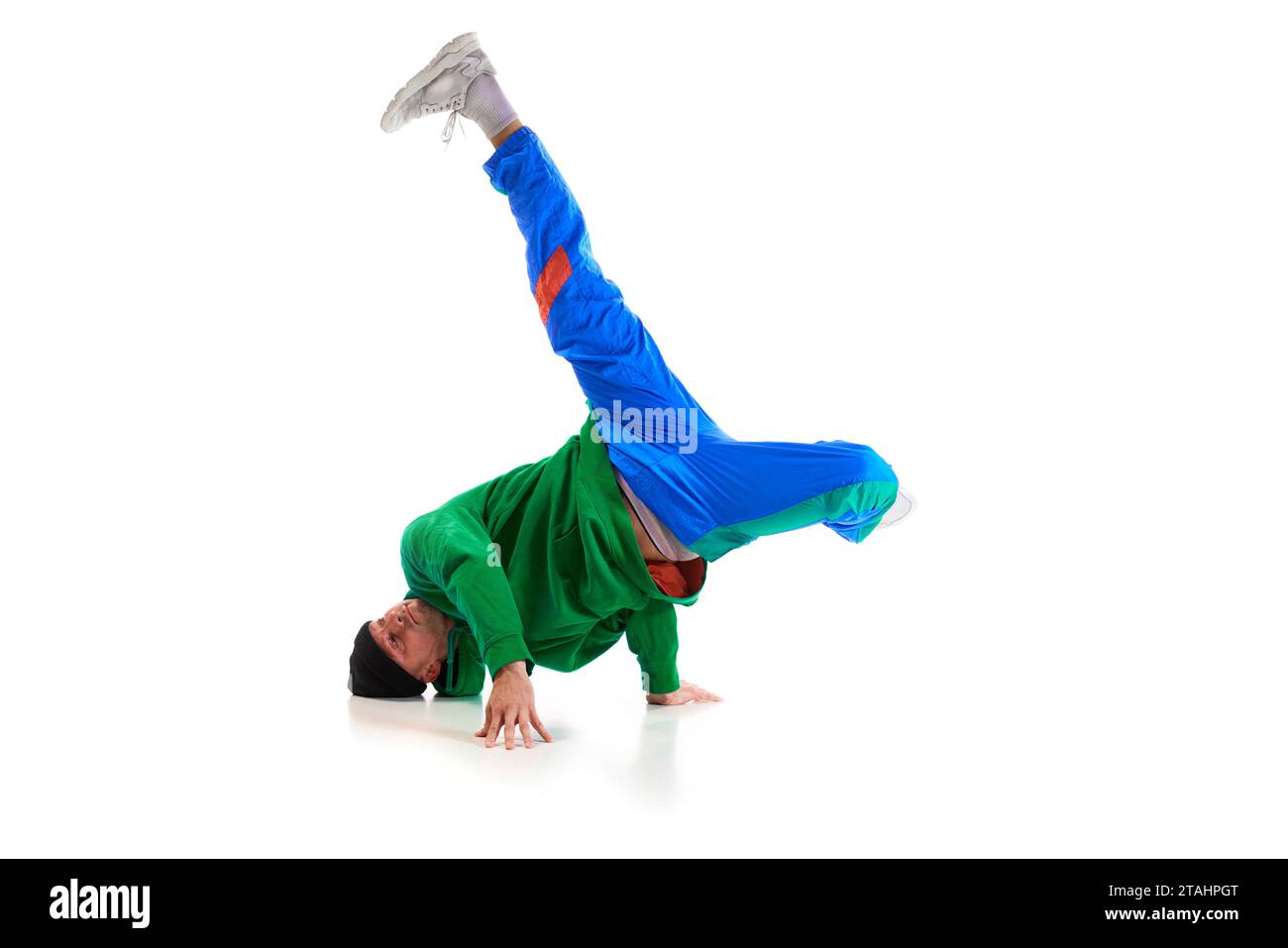 Stylishly dressed man performing freestyle, breakdance, standing on ...