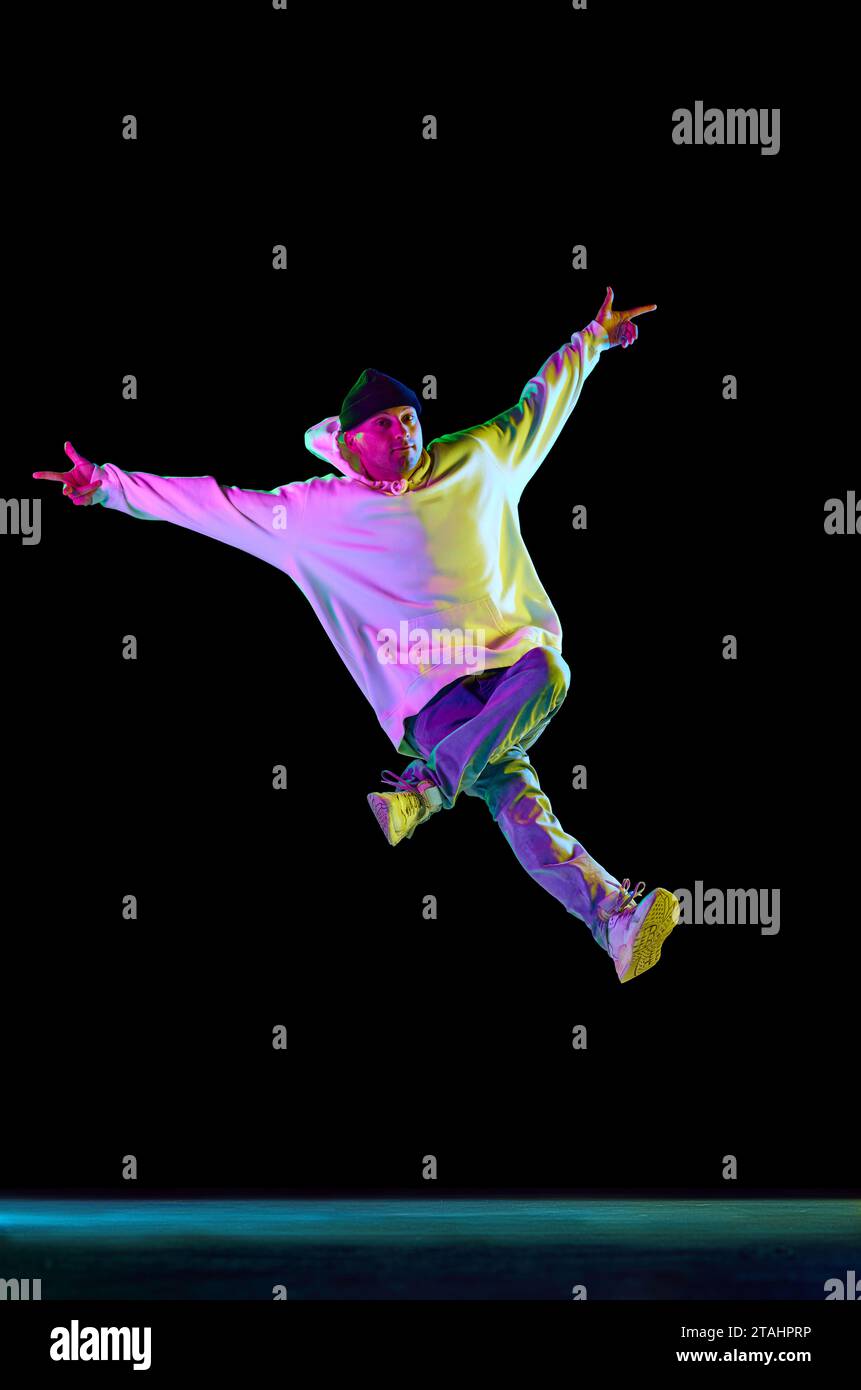 Studio shot of young flexible sportive man dancing breakdance, freezing ...