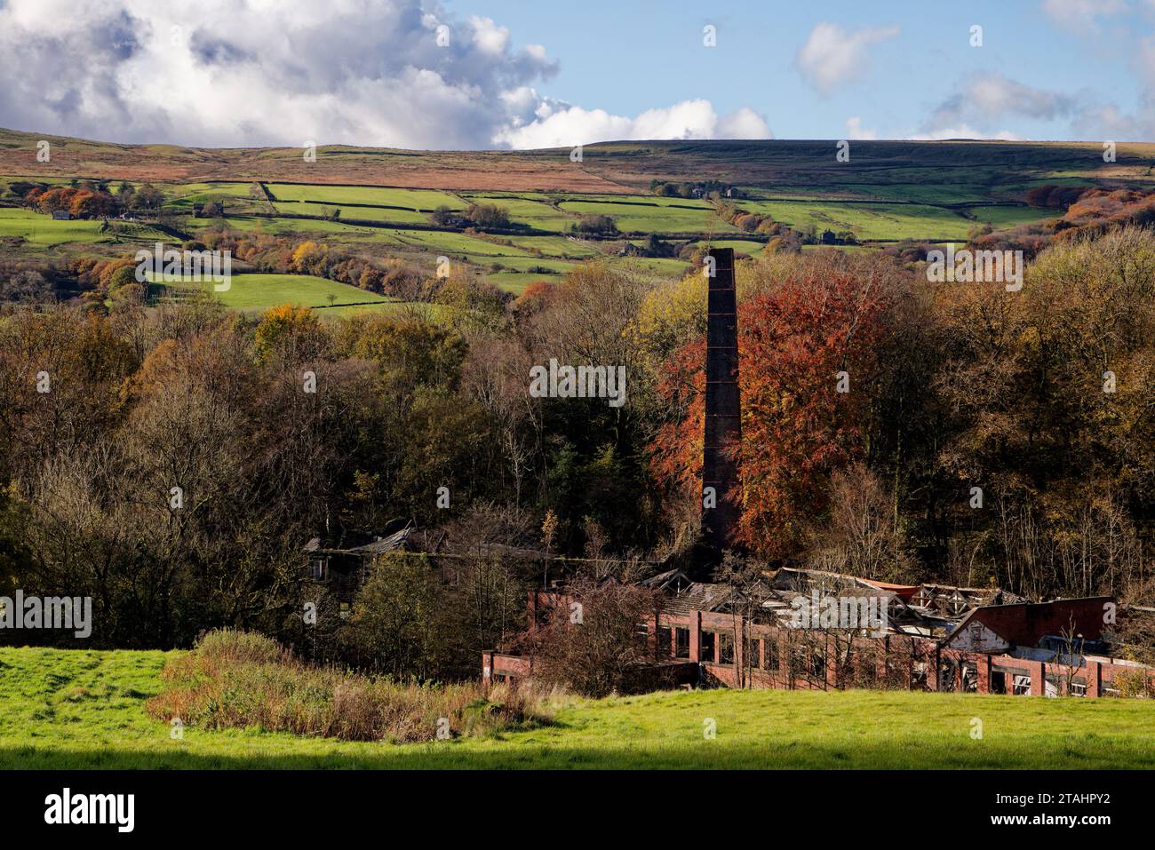 The impressive chimney of Edenwood mill ruins nestled in the valley of ...