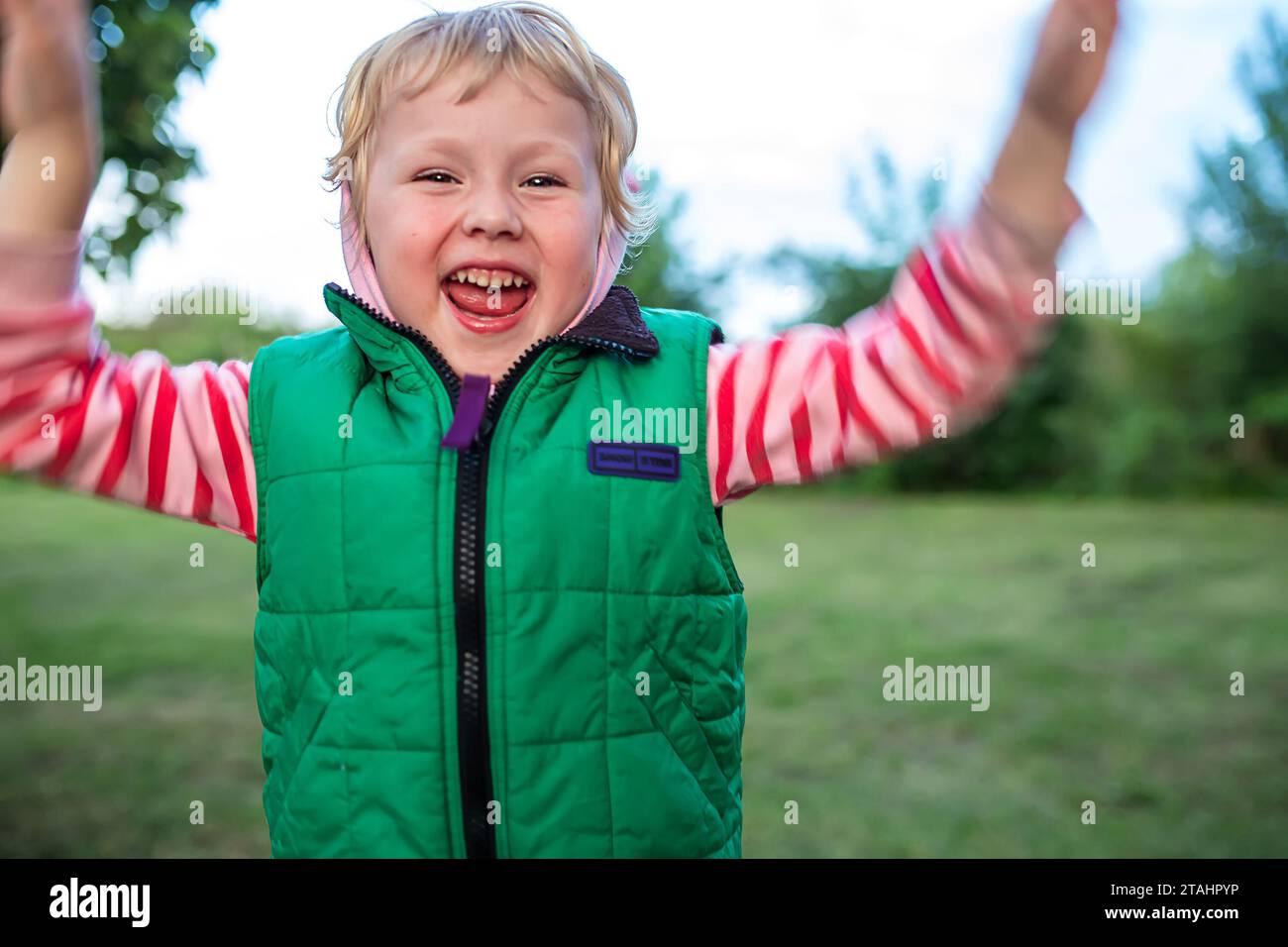 Funny little girl screaming with her mouth open against the background ...
