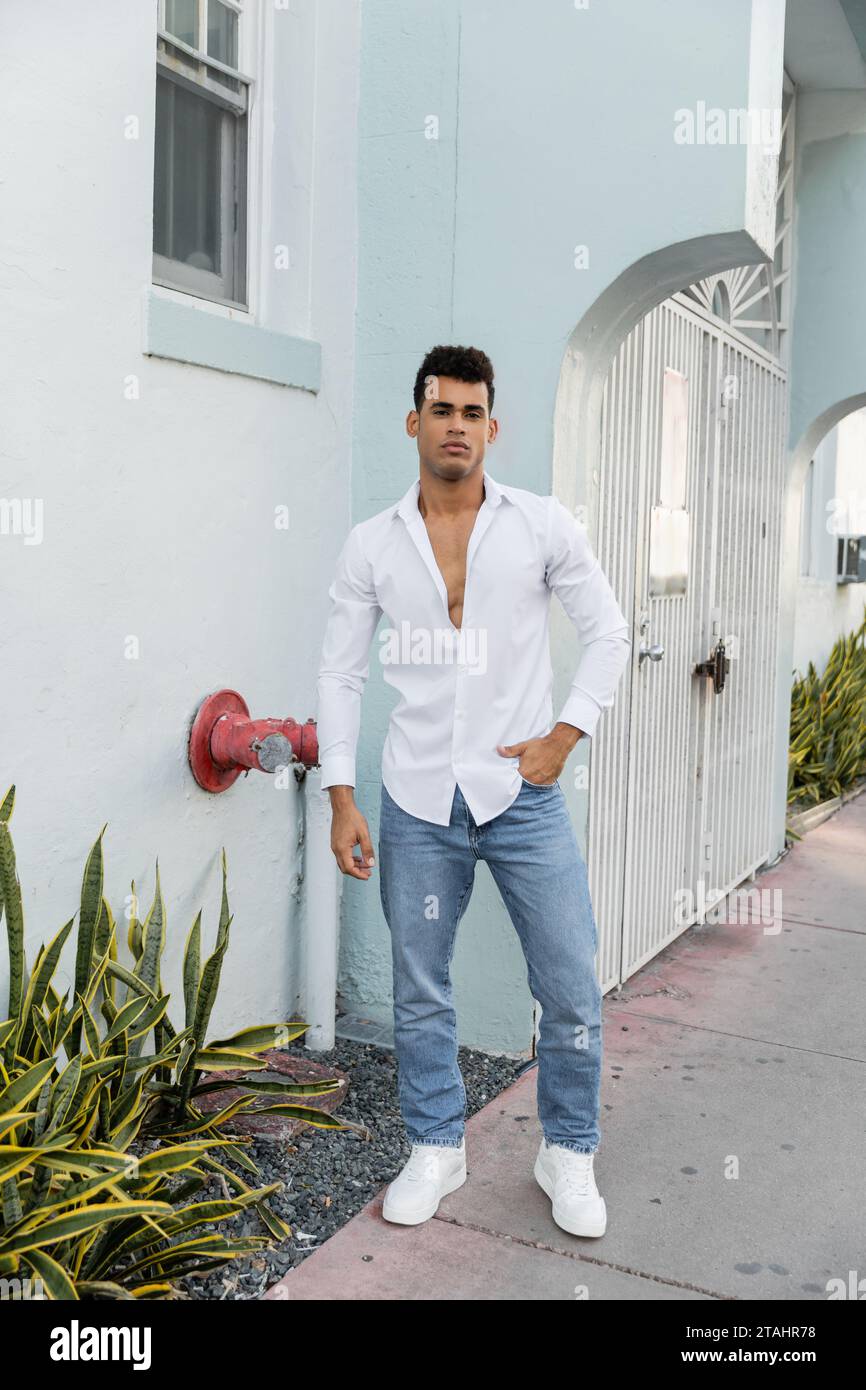 Full length of young cuban man in stylish shirt and blue jeans posing ...