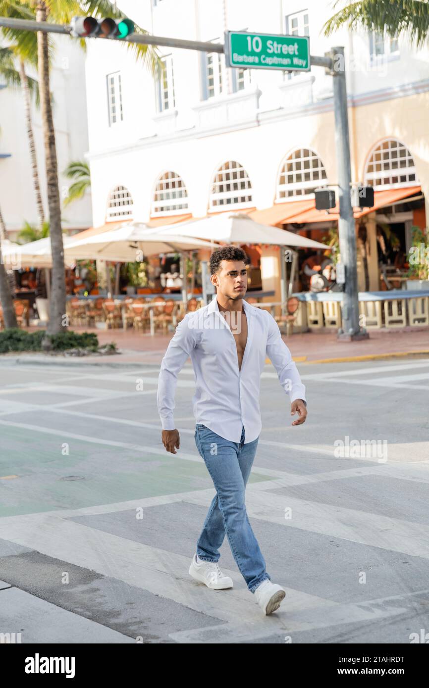 Young latino man walking hi-res stock photography and images - Alamy