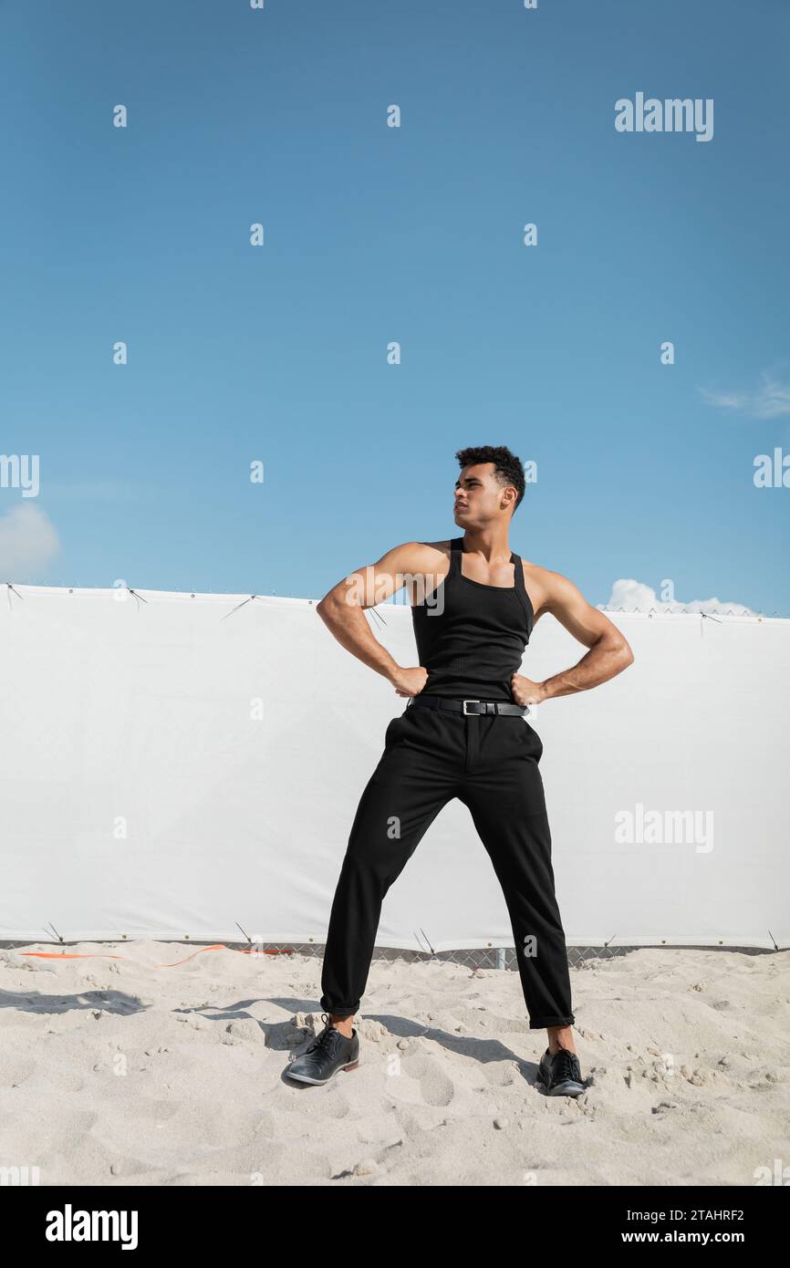 Good looking and muscular young cuban man in black and stylish outfit ...
