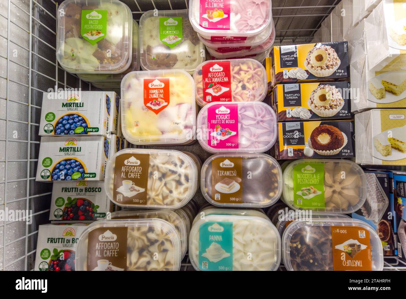 Italy - November 26, 2023: Ice cream of various flavors in plastic tubs ...