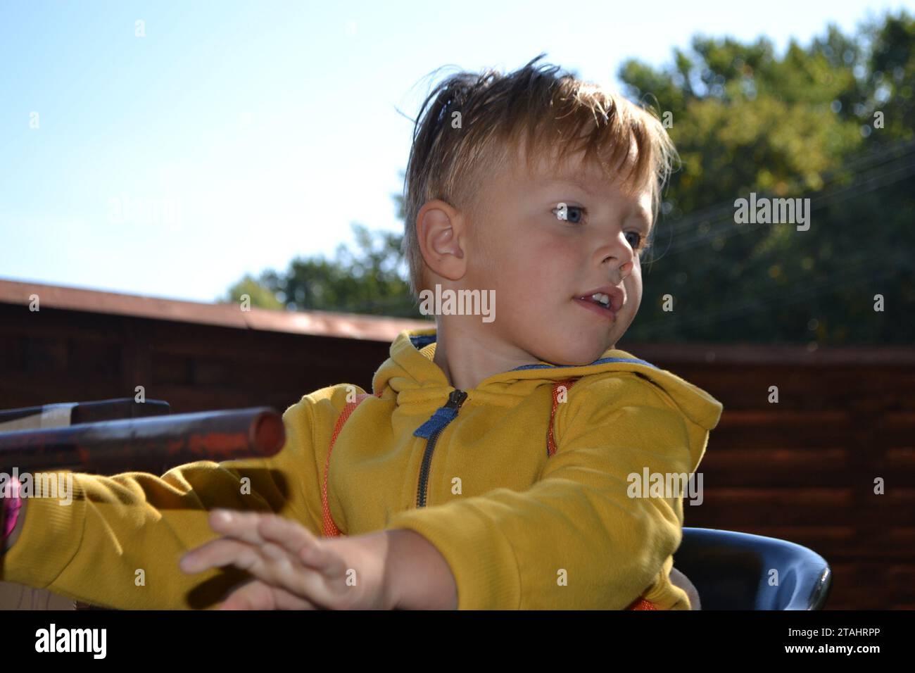 Kids having fun in ferris wheel with chains, carousel ski flyer in ...