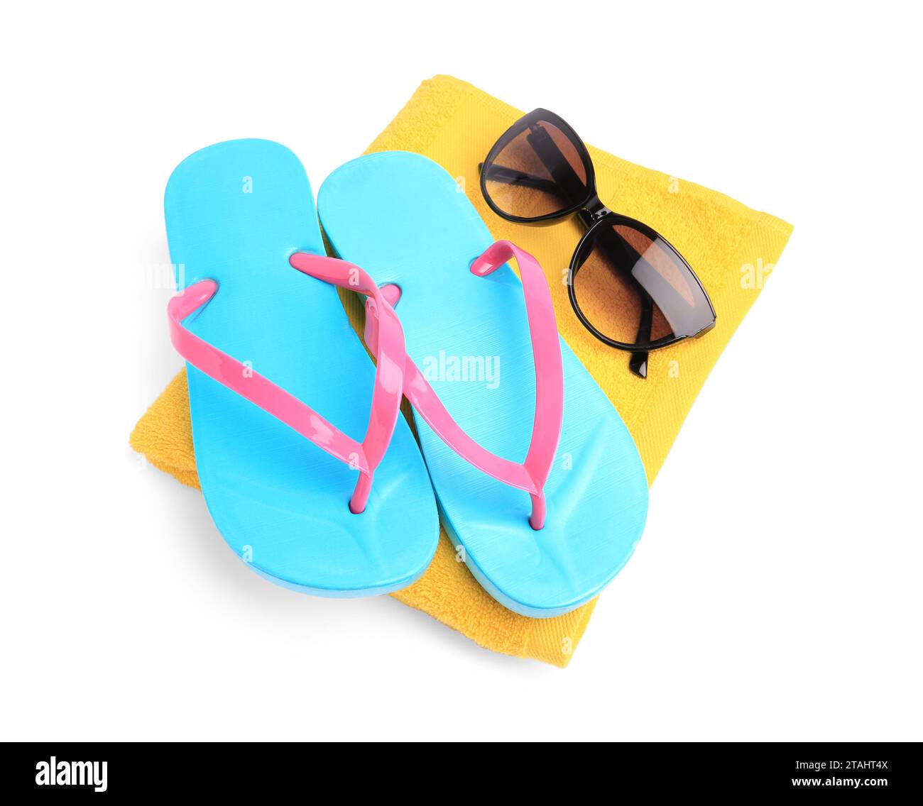 Yellow terry towel, sunglasses and flip flops isolated on white. Beach ...