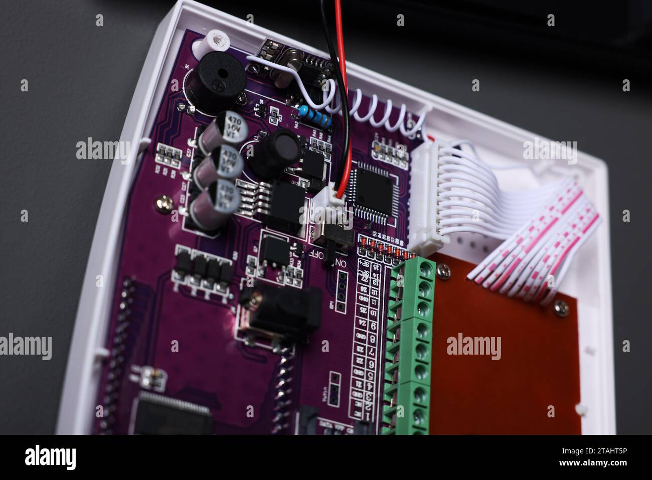Installation of alarm system. Circuit board on gray wall, closeup Stock ...