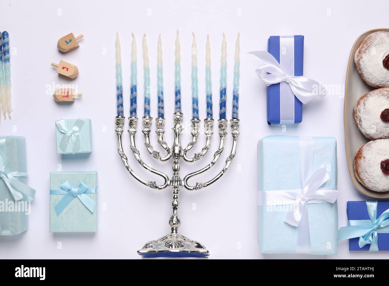 Flat lay composition with Hanukkah menorah and gift boxes on light ...