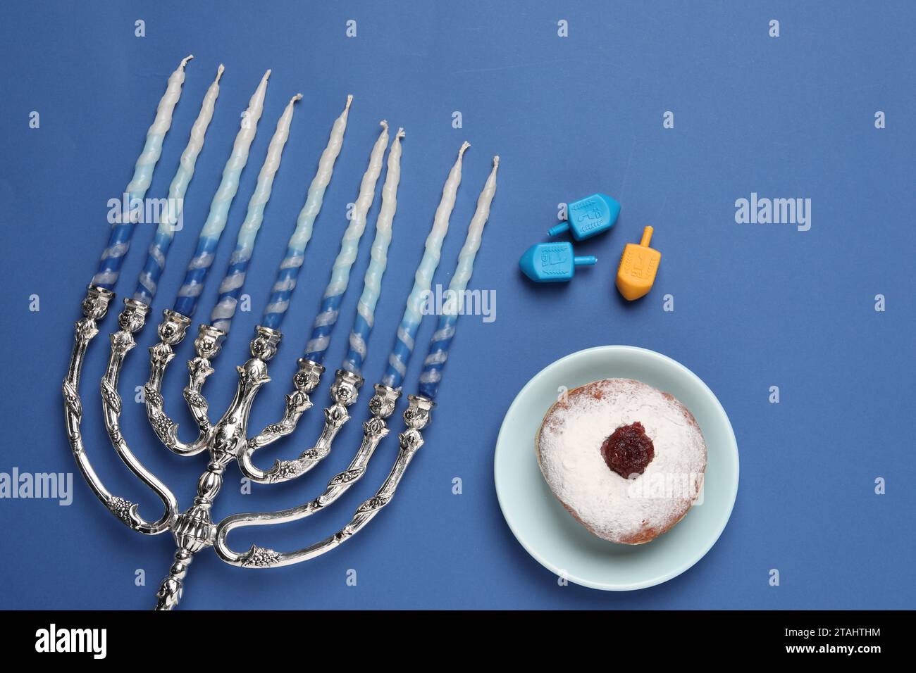 Flat lay composition with Hanukkah menorah on blue background Stock ...