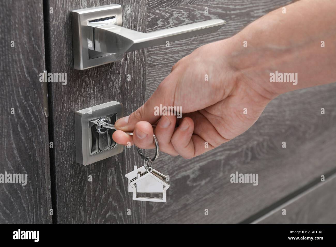 Hand man locking home door hi-res stock photography and images - Alamy
