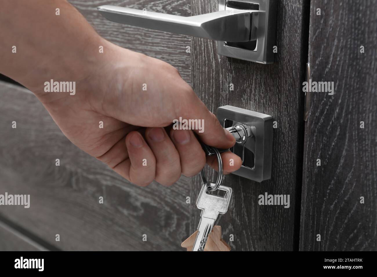 Man unlocking door with key, closeup view Stock Photo - Alamy