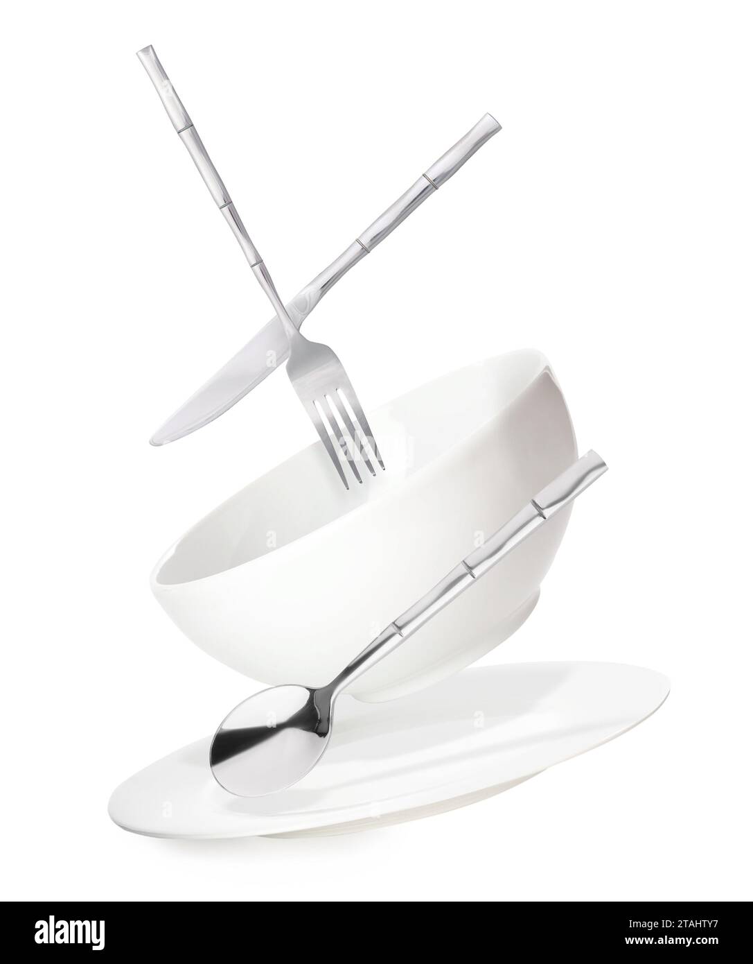Clean dishes, fork, knife and spoon falling on white background Stock ...