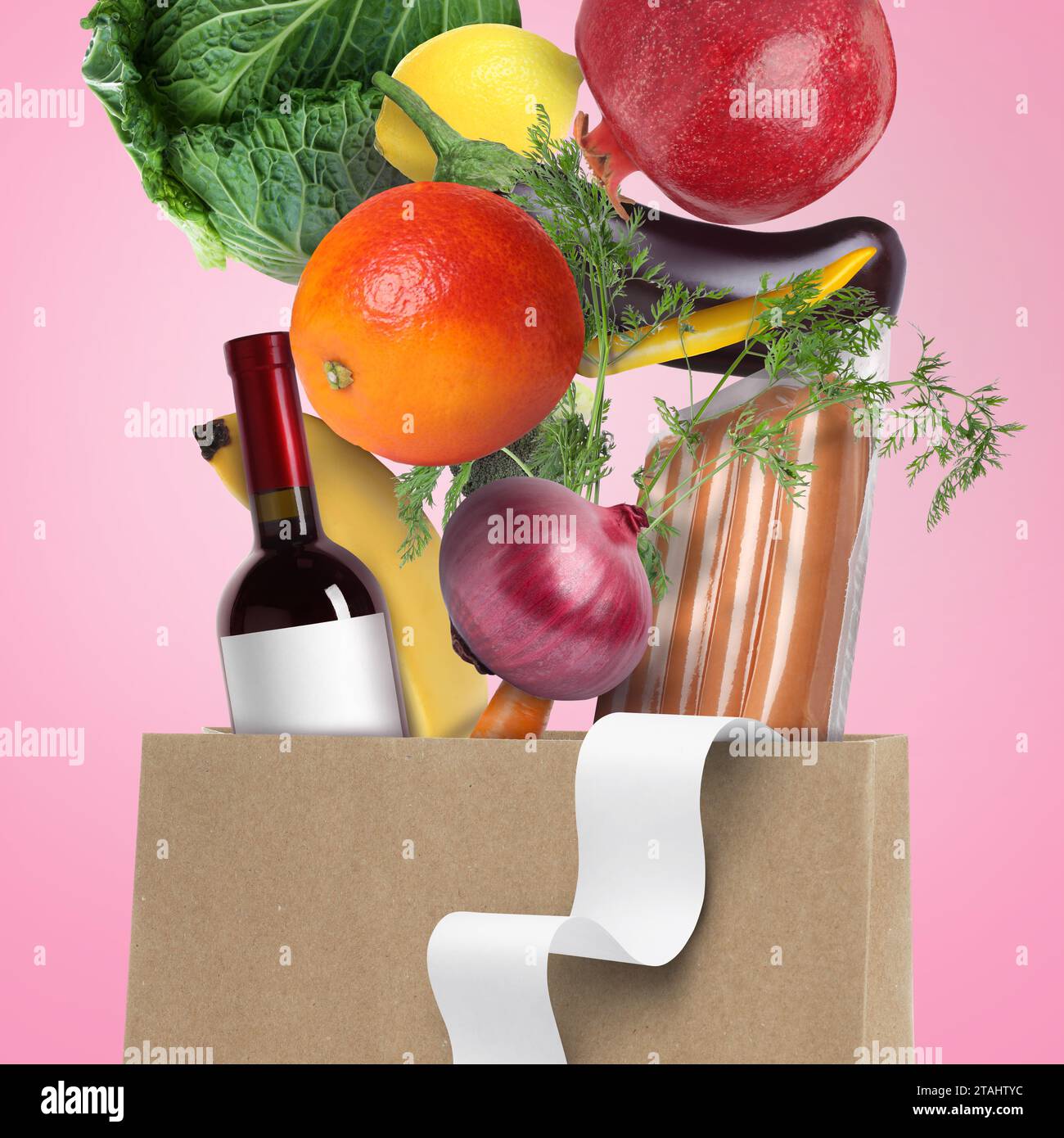 Different food products falling into paper bag on pink background Stock ...