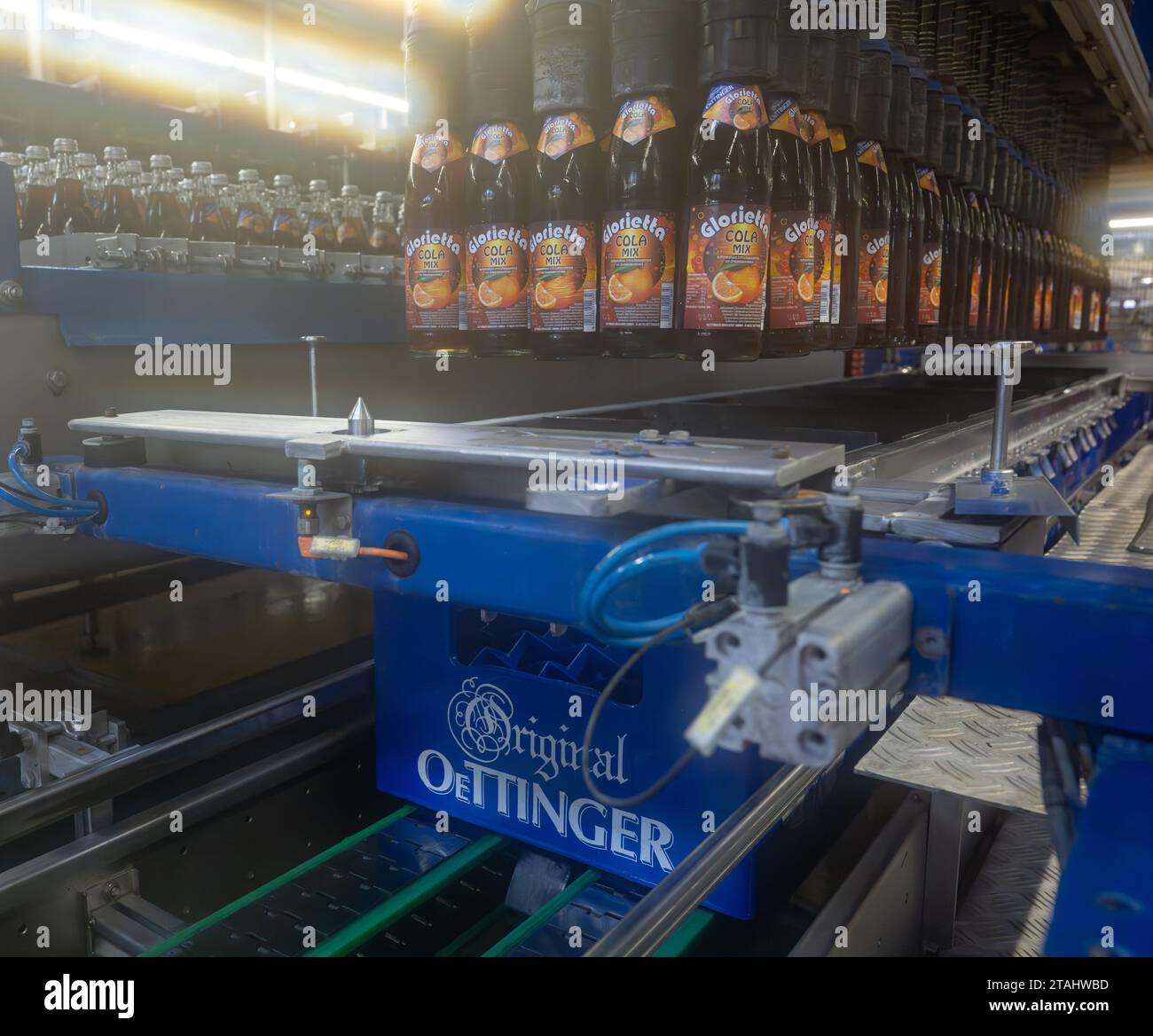 Oettingen, Germany. 01st Dec, 2023. A cola mix drink is filled into ...