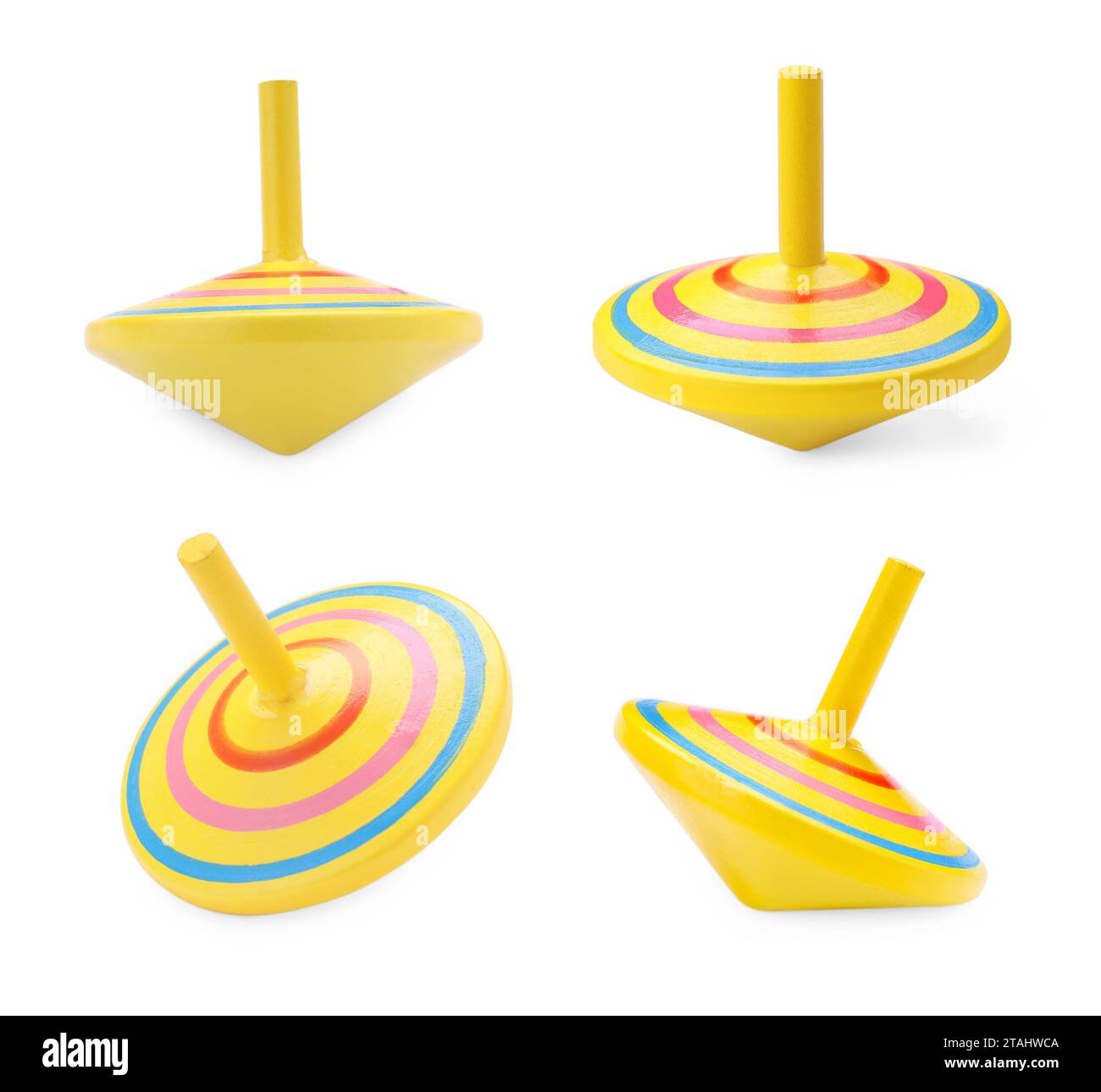Yellow spinning tops isolated on white. Toy whirligig Stock Photo - Alamy