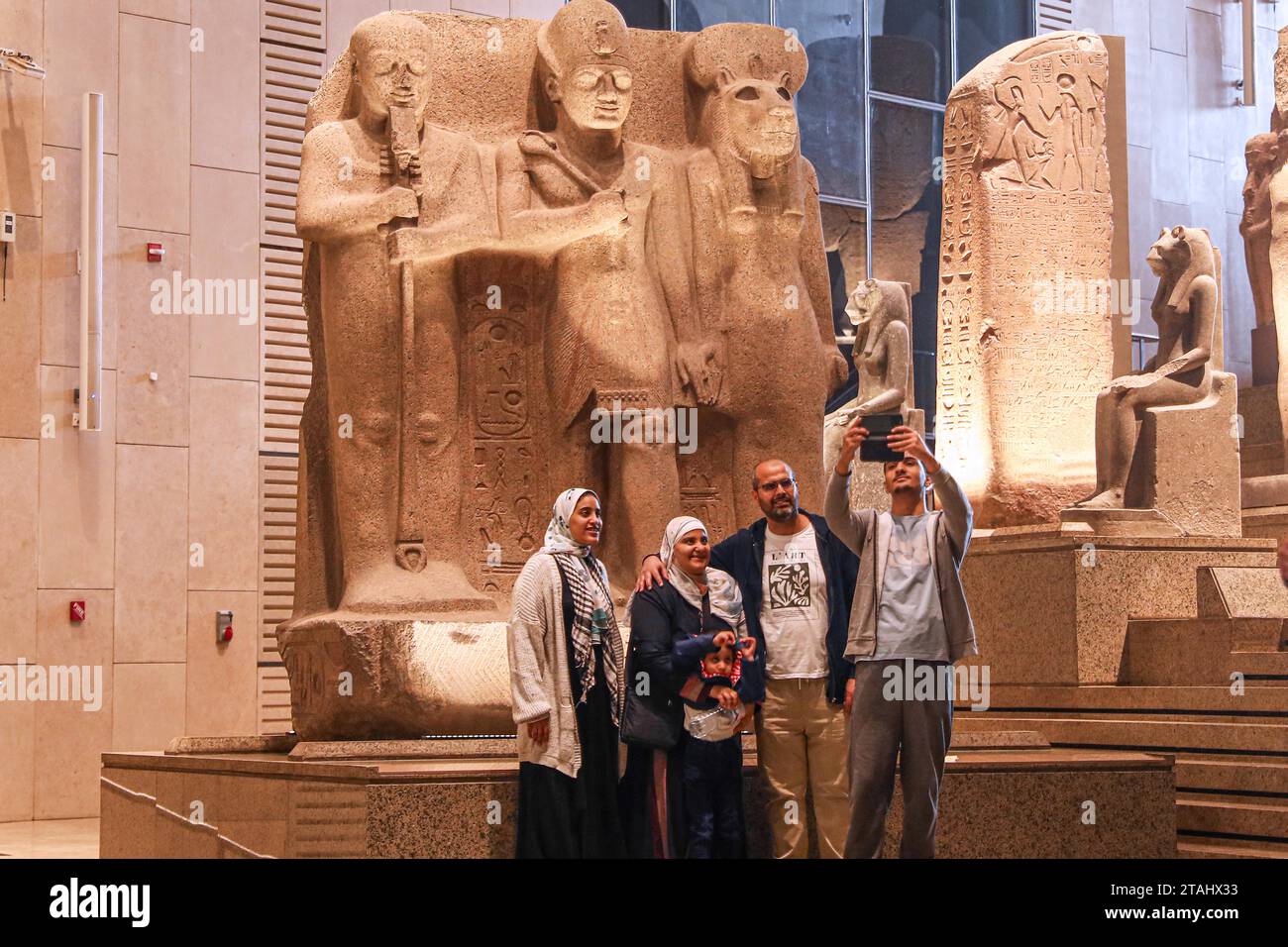 Giza, Egypt. 30th Nov, 2023. Visitors pose for photos with Pharaoh-time ...