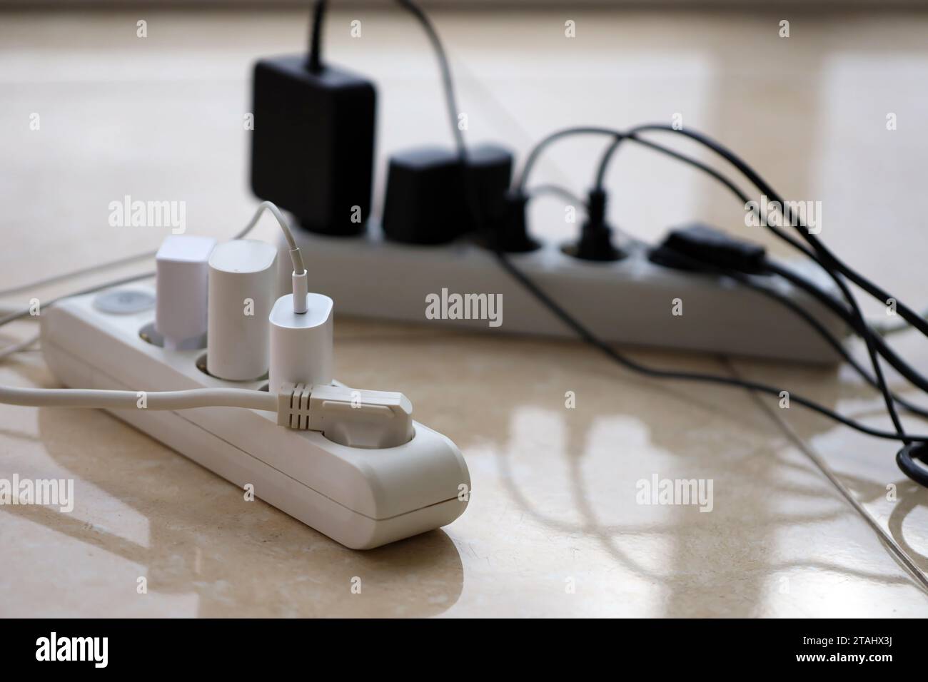 Overloaded power boards. Power strips with different electrical plugs ...