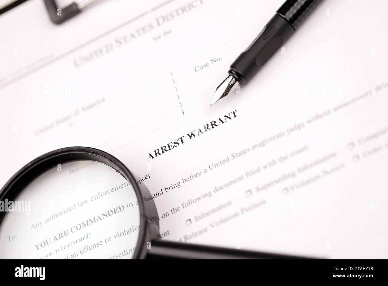 District Court Arrest Warrant court papers on A4 tablet lies on office ...