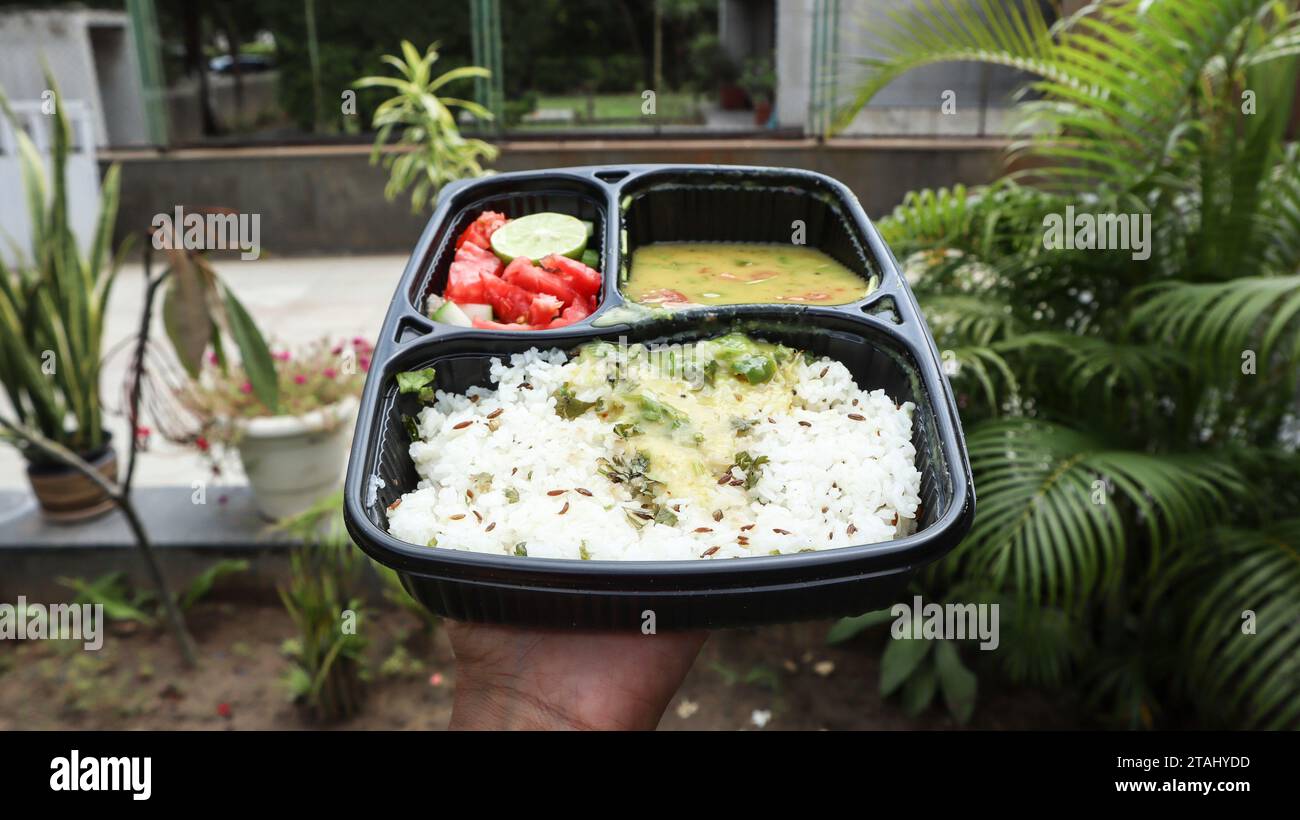 Indian traditional and popular Lunch item Kadhi Chawal in Parcel food ...