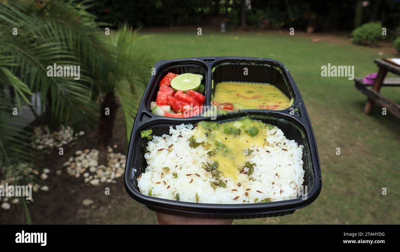 Indian traditional and popular Lunch item Kadhi Chawal in Parcel food ...