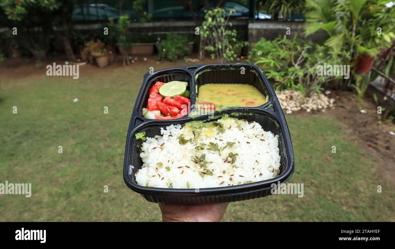 Indian traditional and popular Lunch item Kadhi Chawal in Parcel food ...