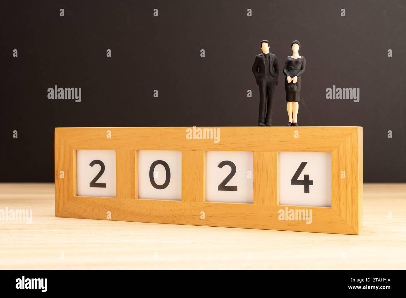 2024 new year concept. Man and woman figurine on top of 2024 sign. Copy ...