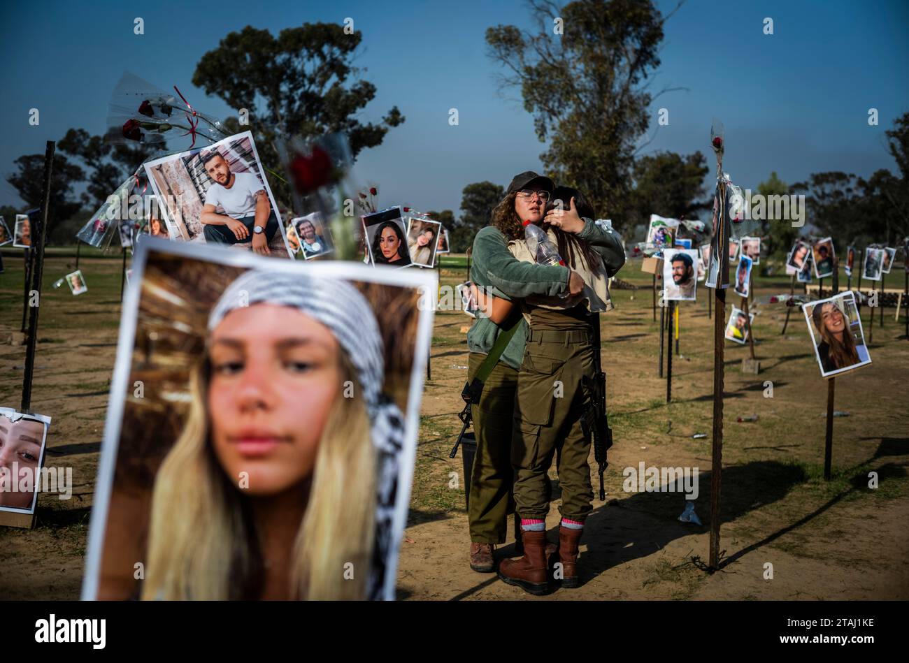 01 December 2023, Israel, Re'im: Israeli soldiers mourn next to the ...