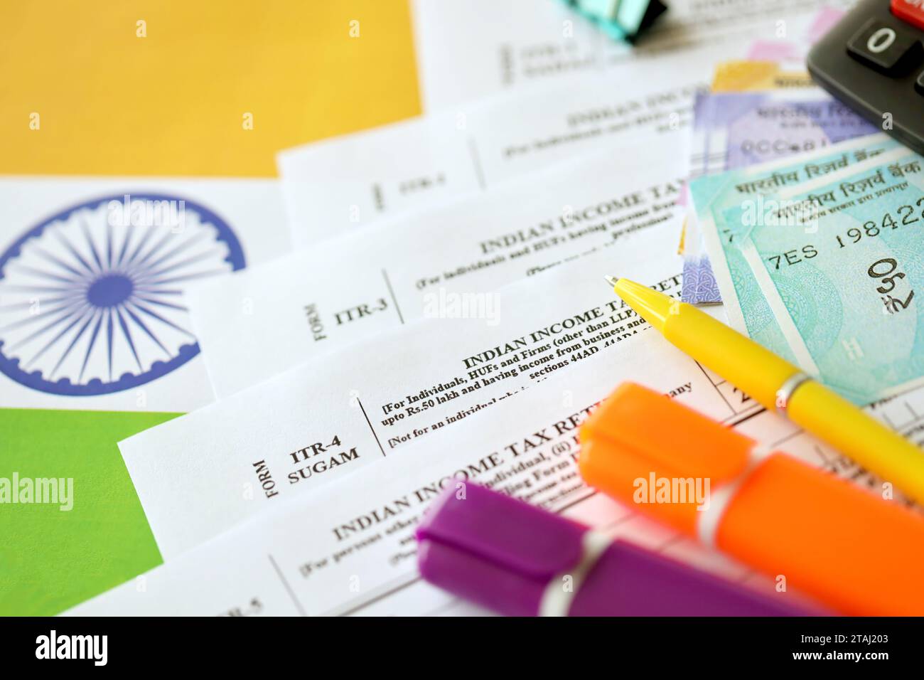 Indian income tax return blank form with pen and indian rupees bills on ...