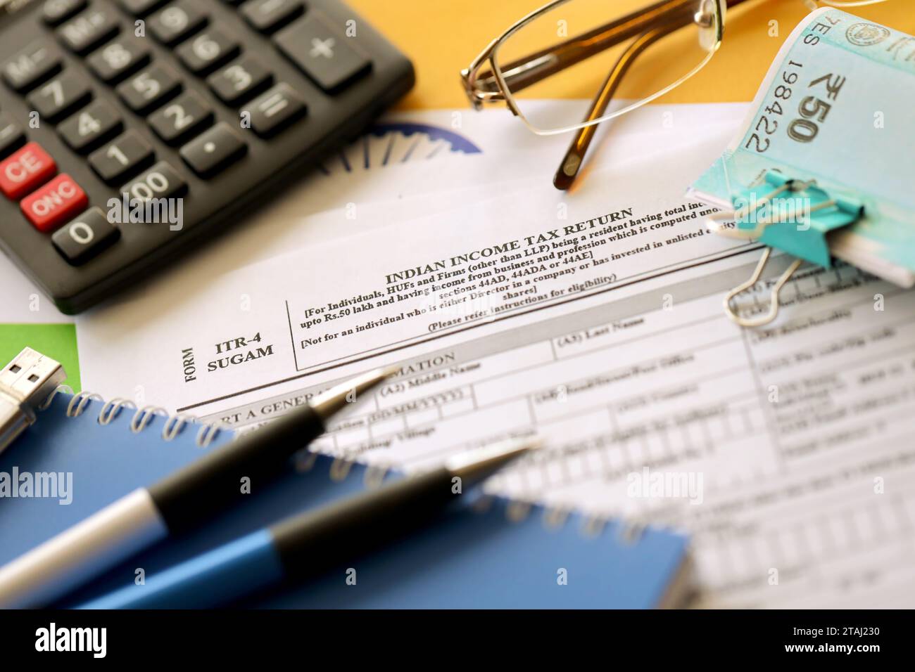 Indian income tax return blank form with pen and indian rupees bills on ...