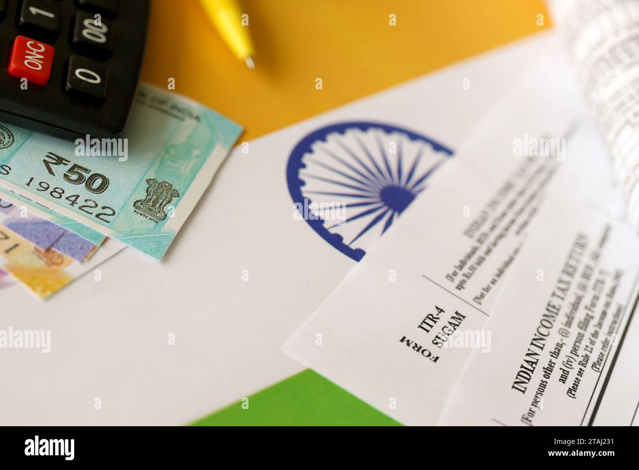 Indian income tax return blank form with pen and indian rupees bills on ...