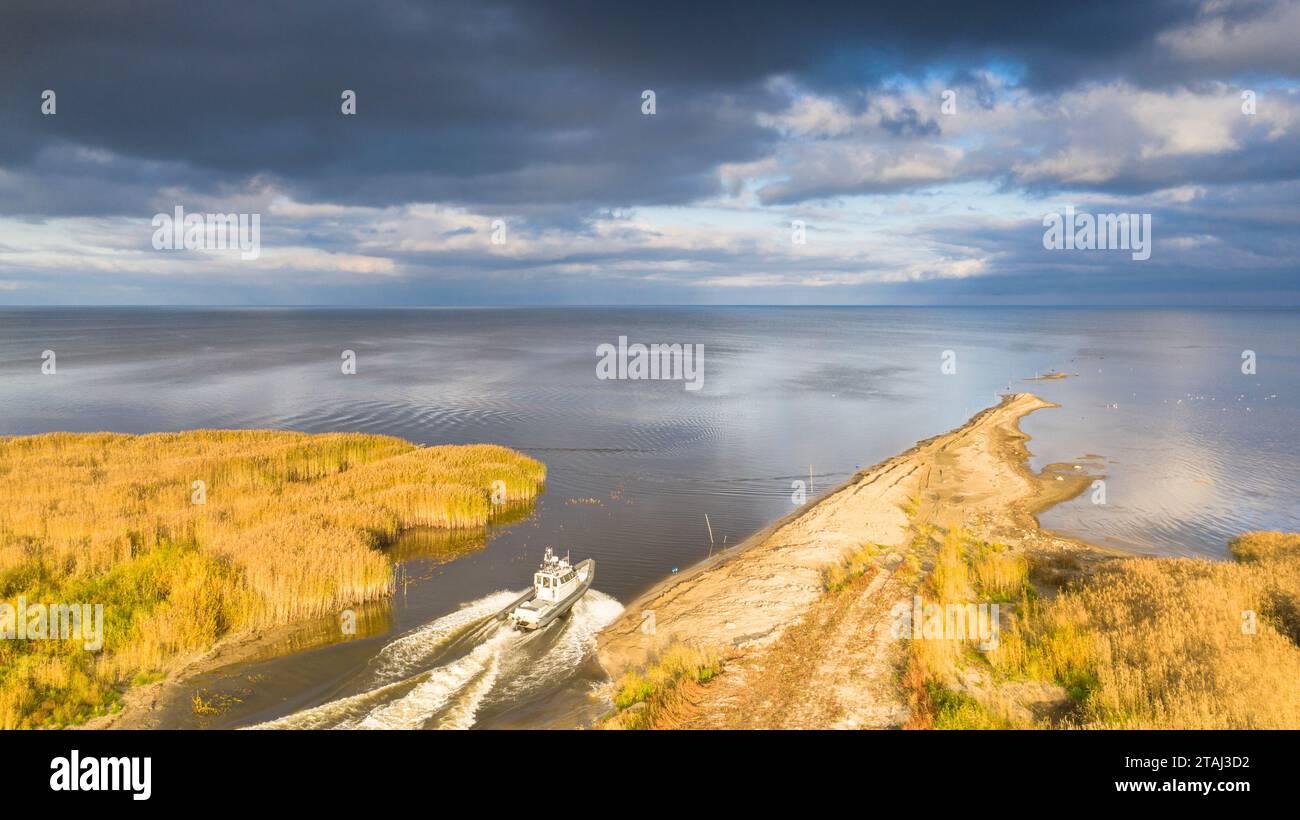 Aerial view to the speedboat and autumn colored shallow and sandy ...