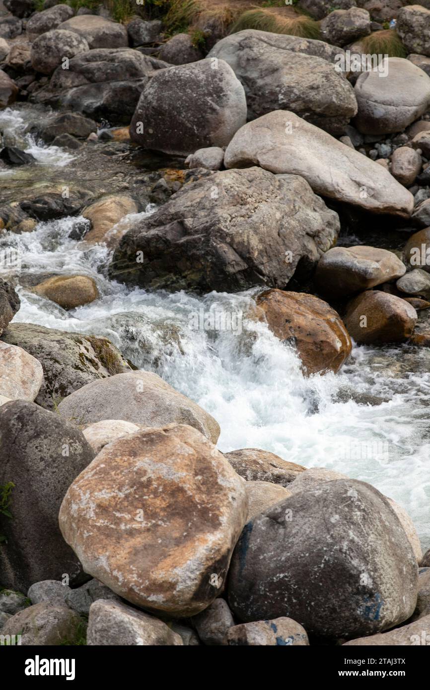 Water flows among the stones. Flow of water and stones. Stones in ...