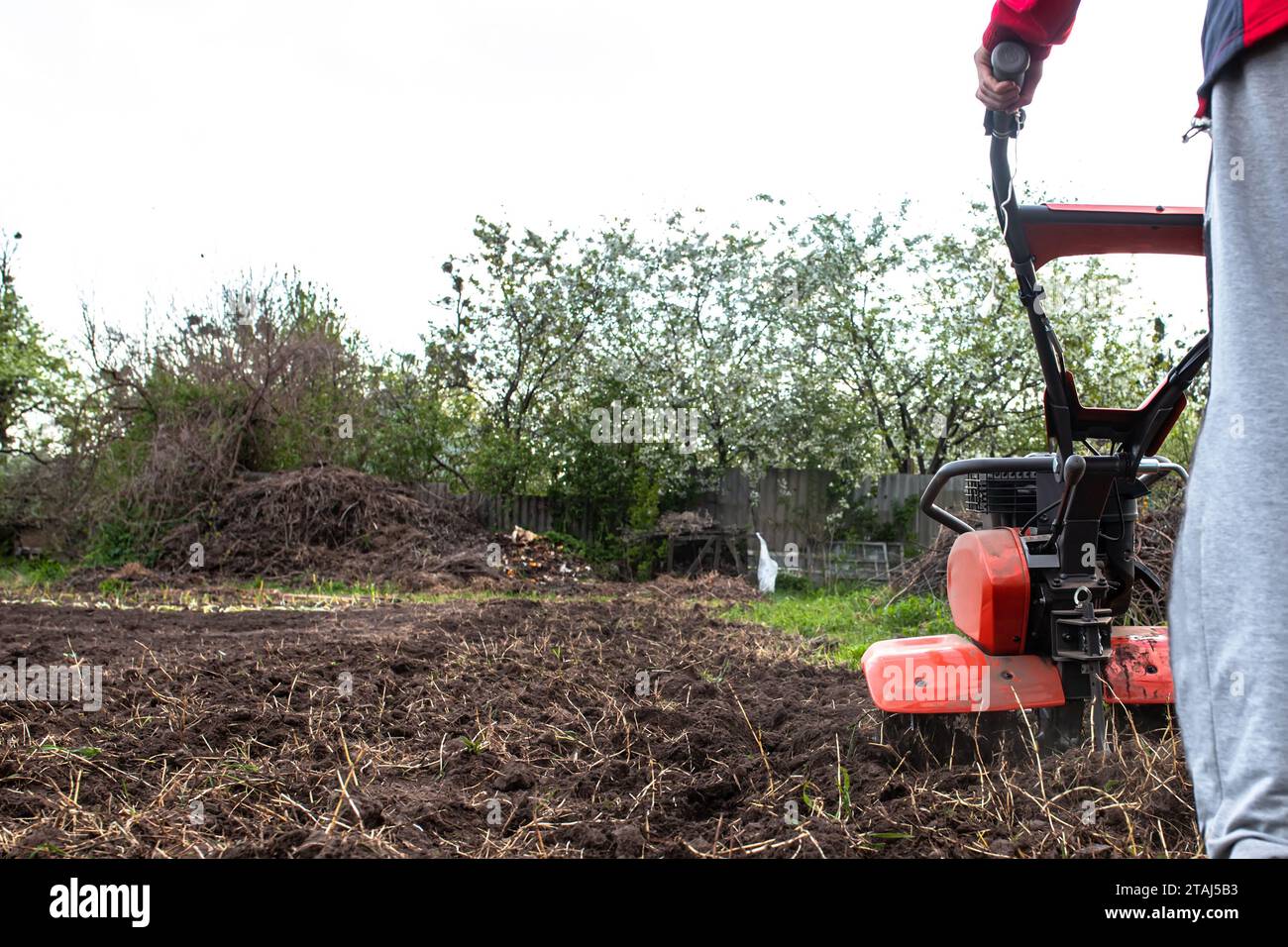 Motor cultivator with a raised front wheel and a furrow inserted into ...