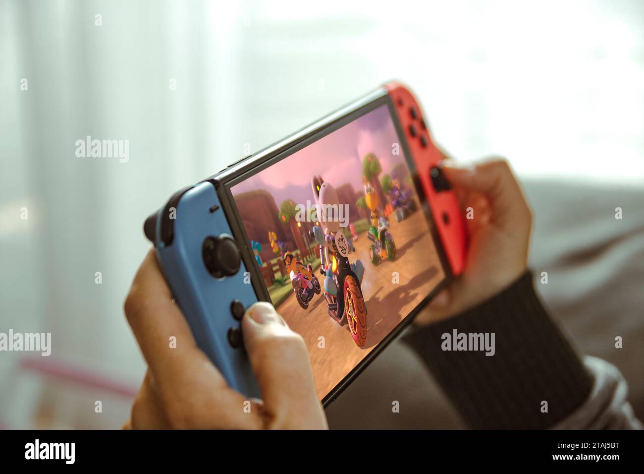 Barcelona, Dec 1st 2023: Young woman playing with a Nintendo Switch ...