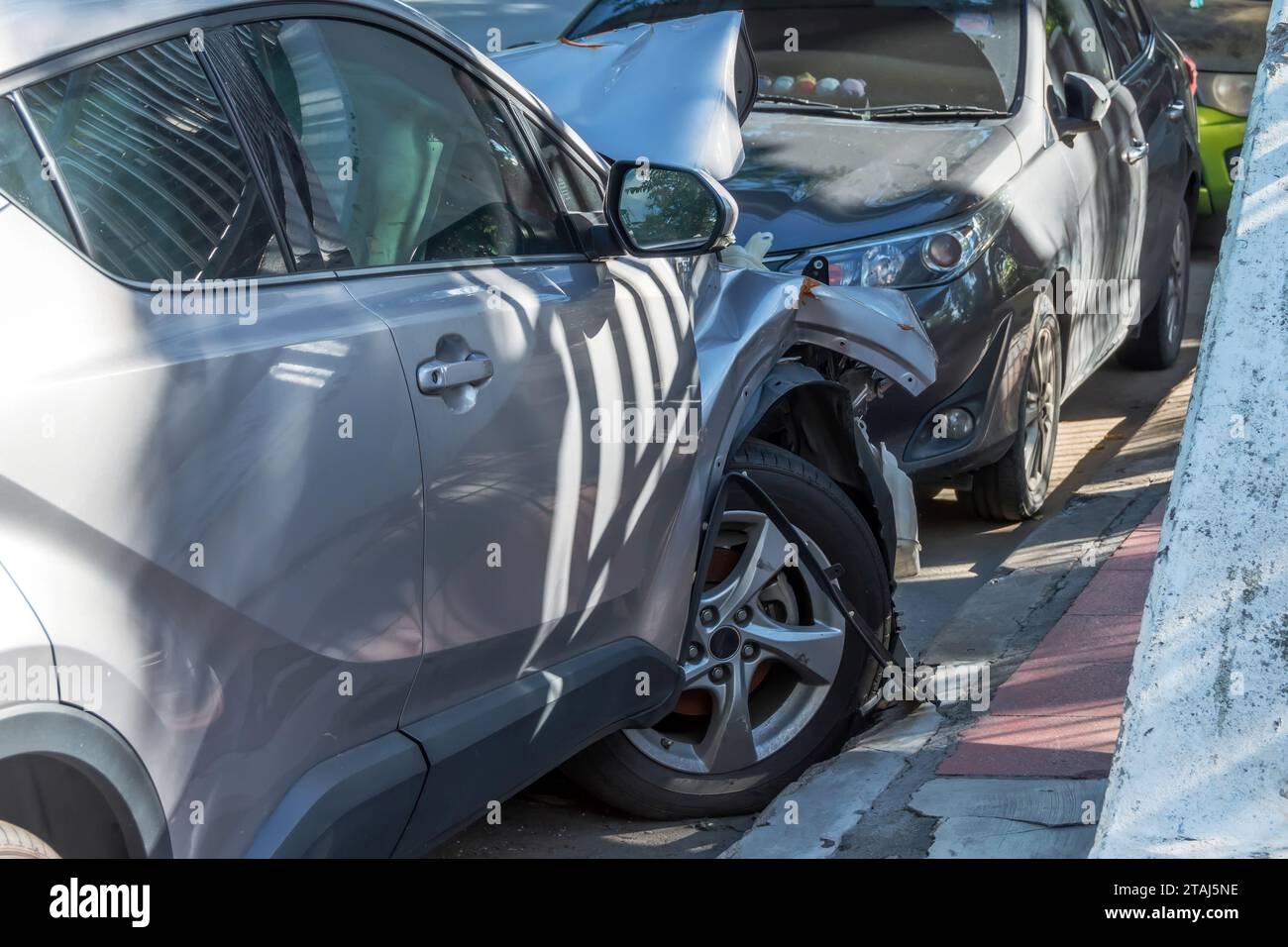 Car crashed into parked car on neighborhood street Stock Photo - Alamy