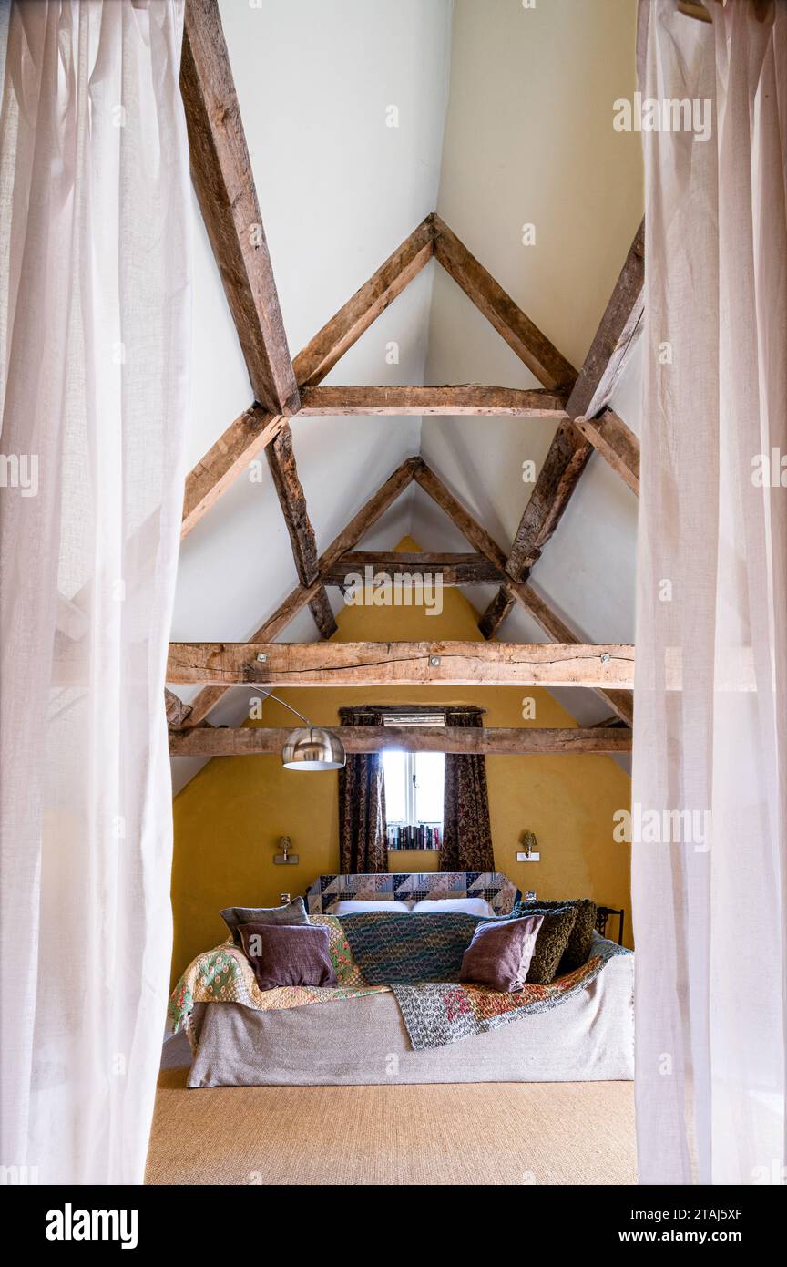Sofa under spacious beamed attic ceiling in Georgian barn conversion ...