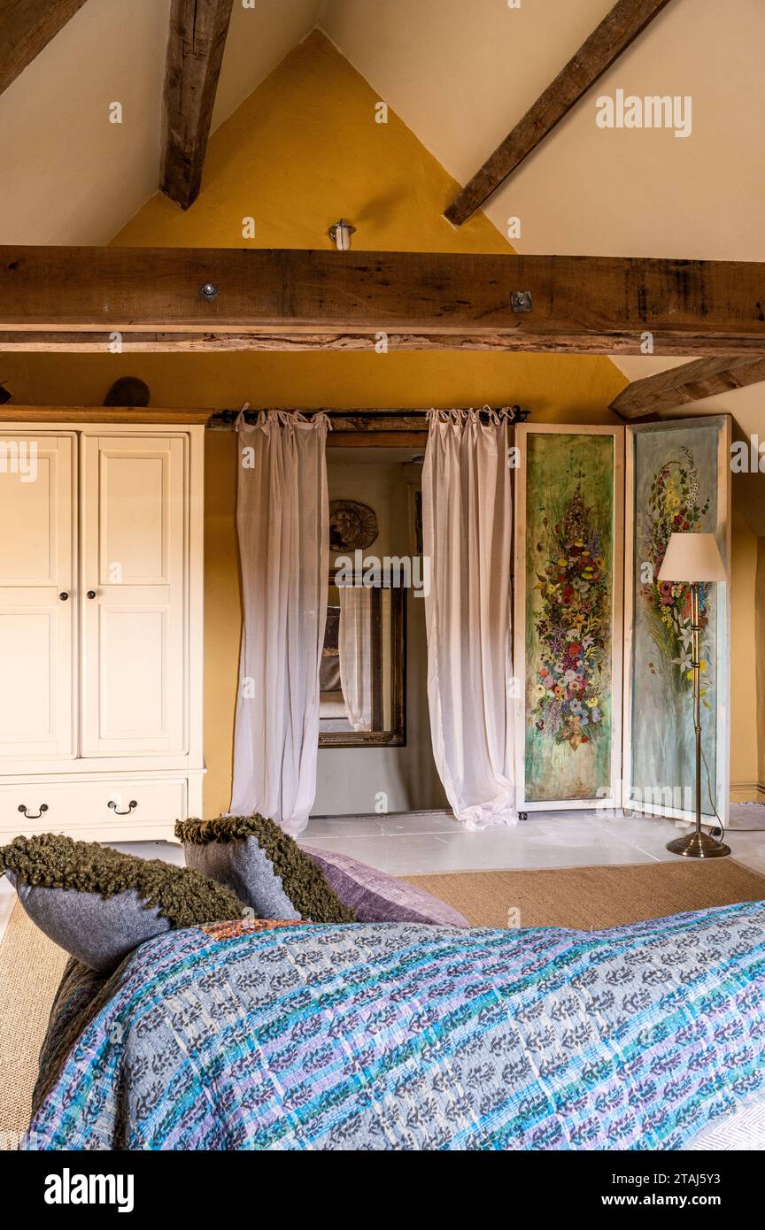 Folding screen and wardrobe with door curtain in attic bedroom ...