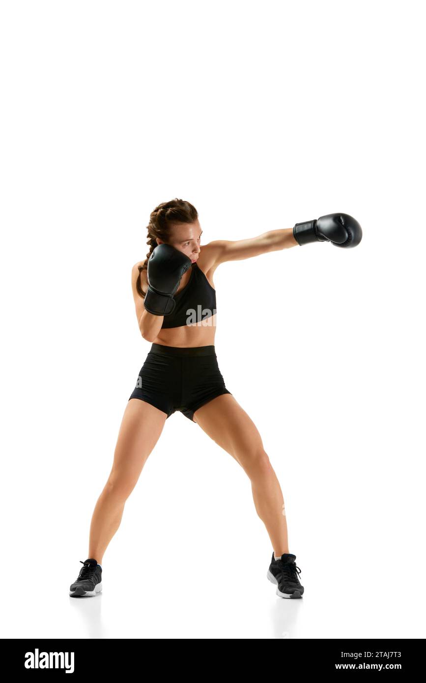 Striking image of female professional boxer in action, wearing gloves ...