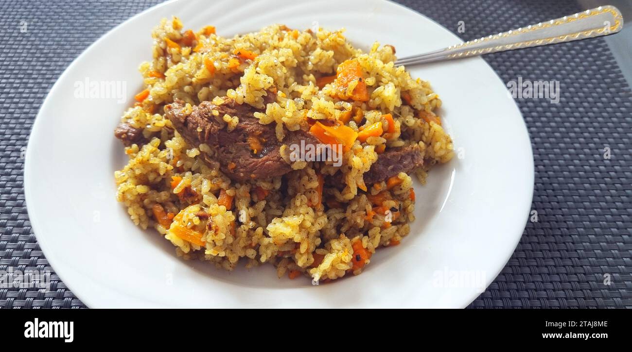 Close up shot of the plov, dish from Uzbel traditional cuisine made of ...