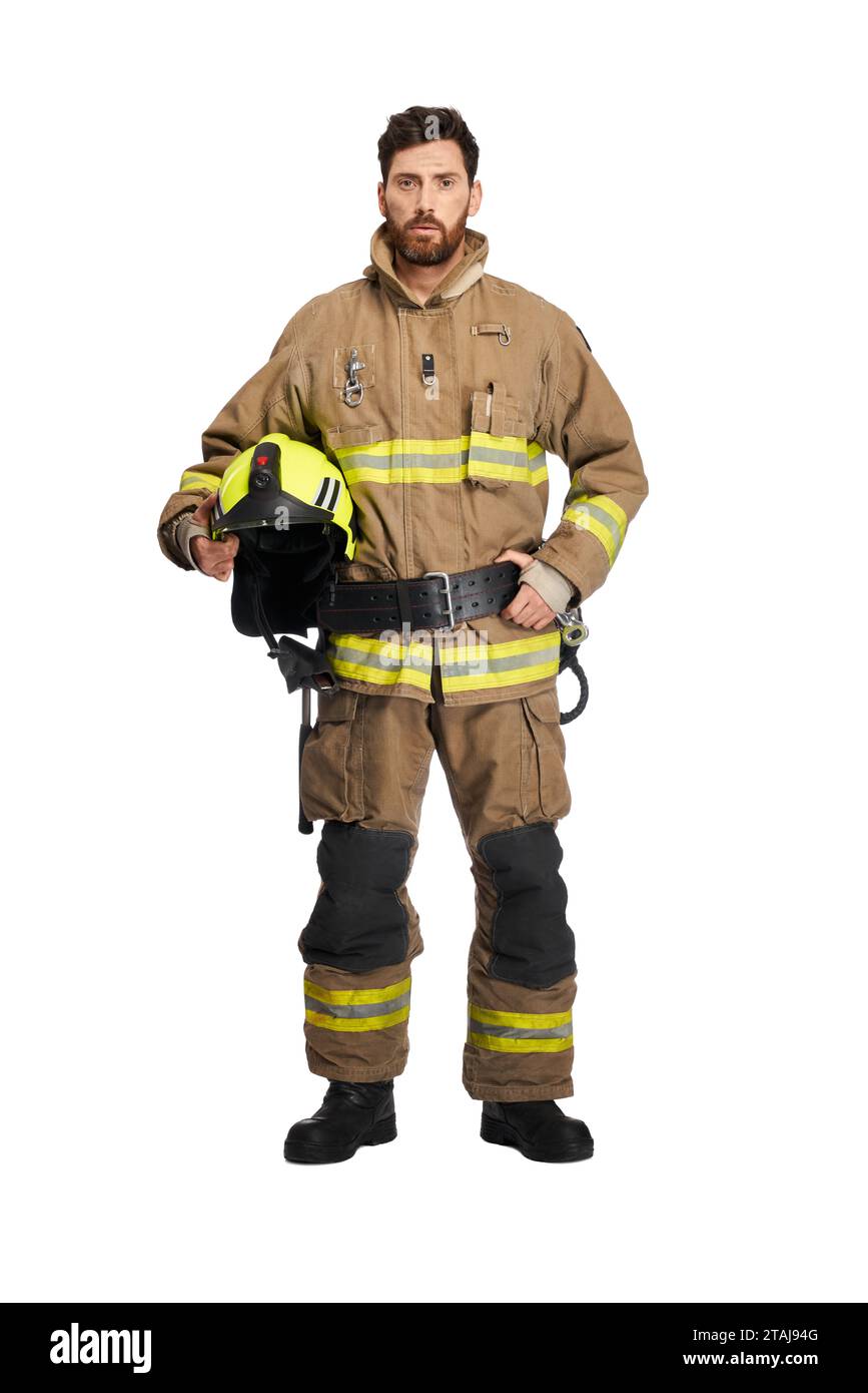 Serious bearded firefighter in uniform holding protective helmet in ...