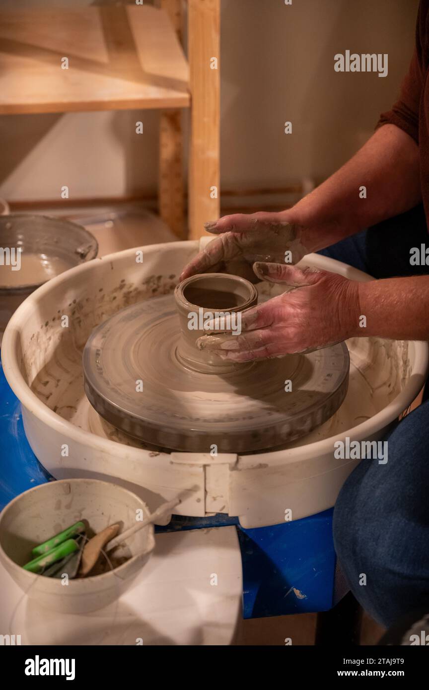 Potters wheel with hands forming clay to art Stock Photo - Alamy
