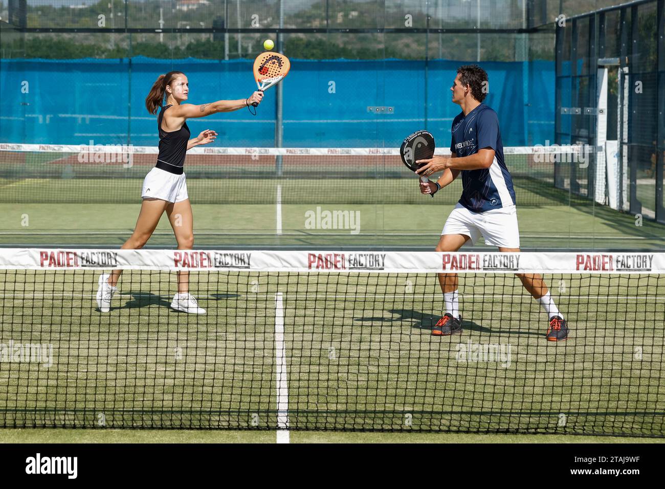 Young couple playing padel tennis Stock Photo - Alamy