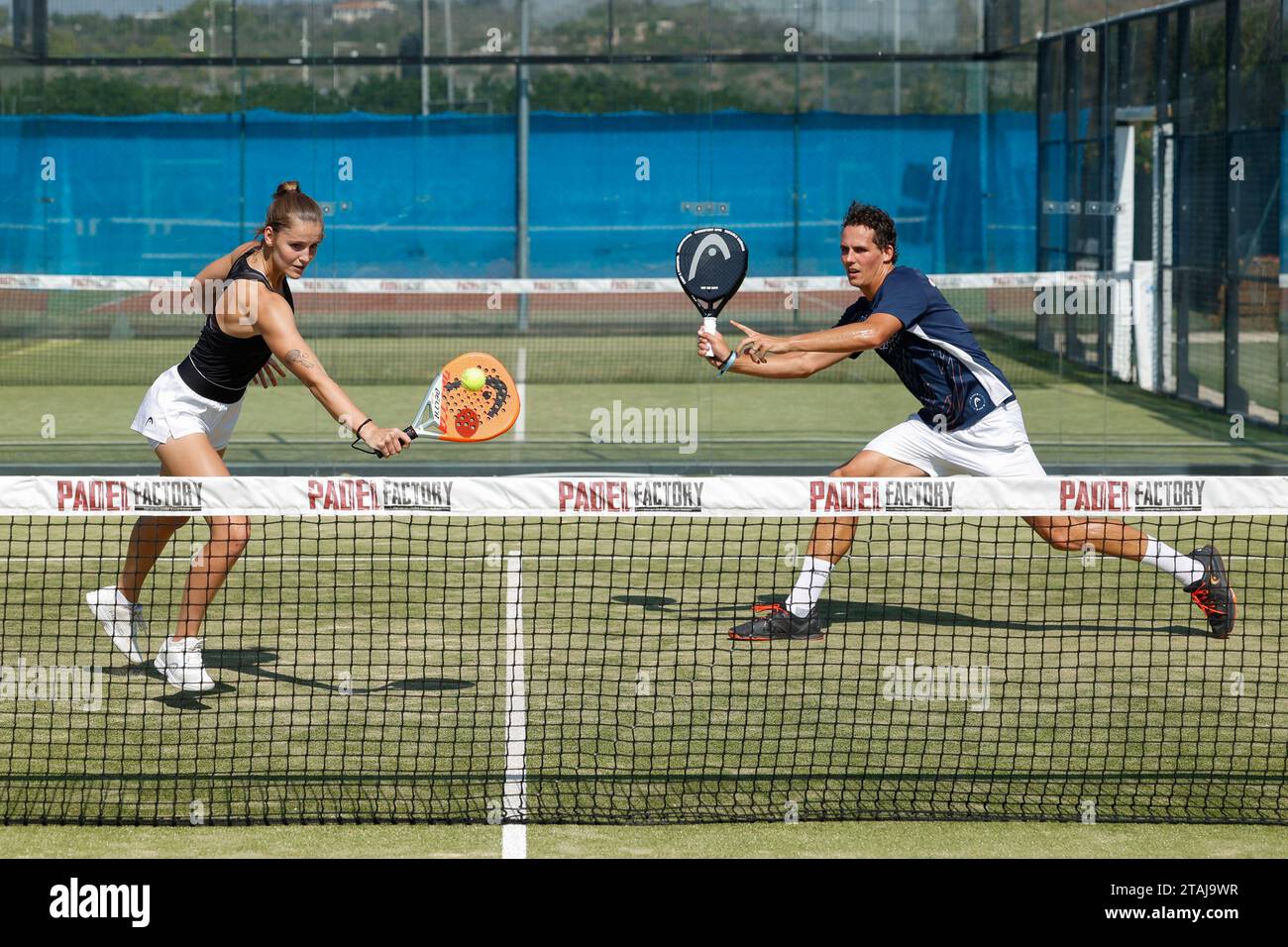 Young couple playing padel tennis Stock Photo - Alamy