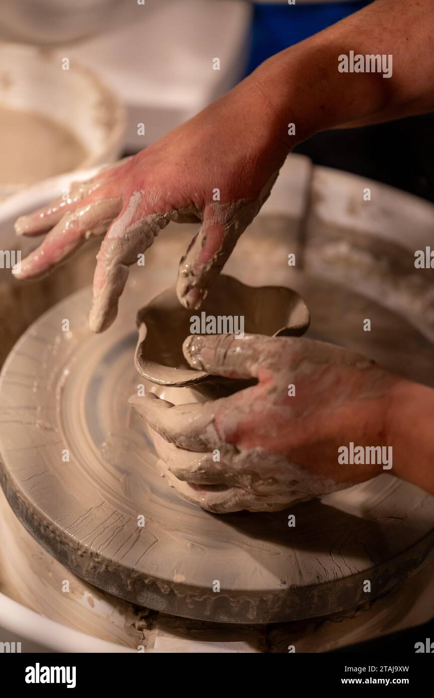 Potters wheel with hands forming clay to art Stock Photo - Alamy