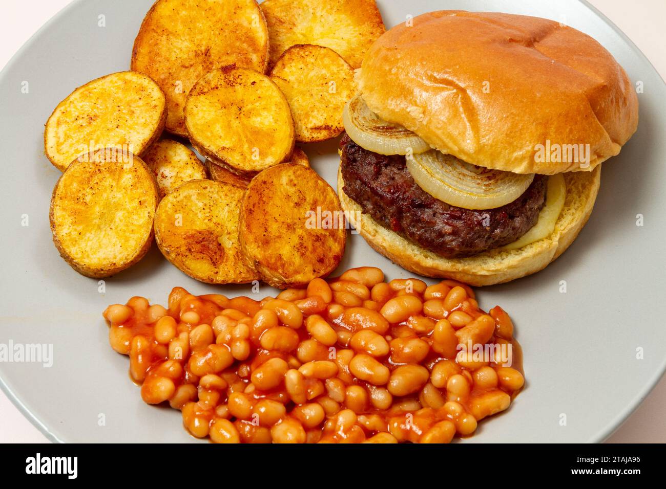 Burger saute potatoe slices and baked beans Stock Photo - Alamy