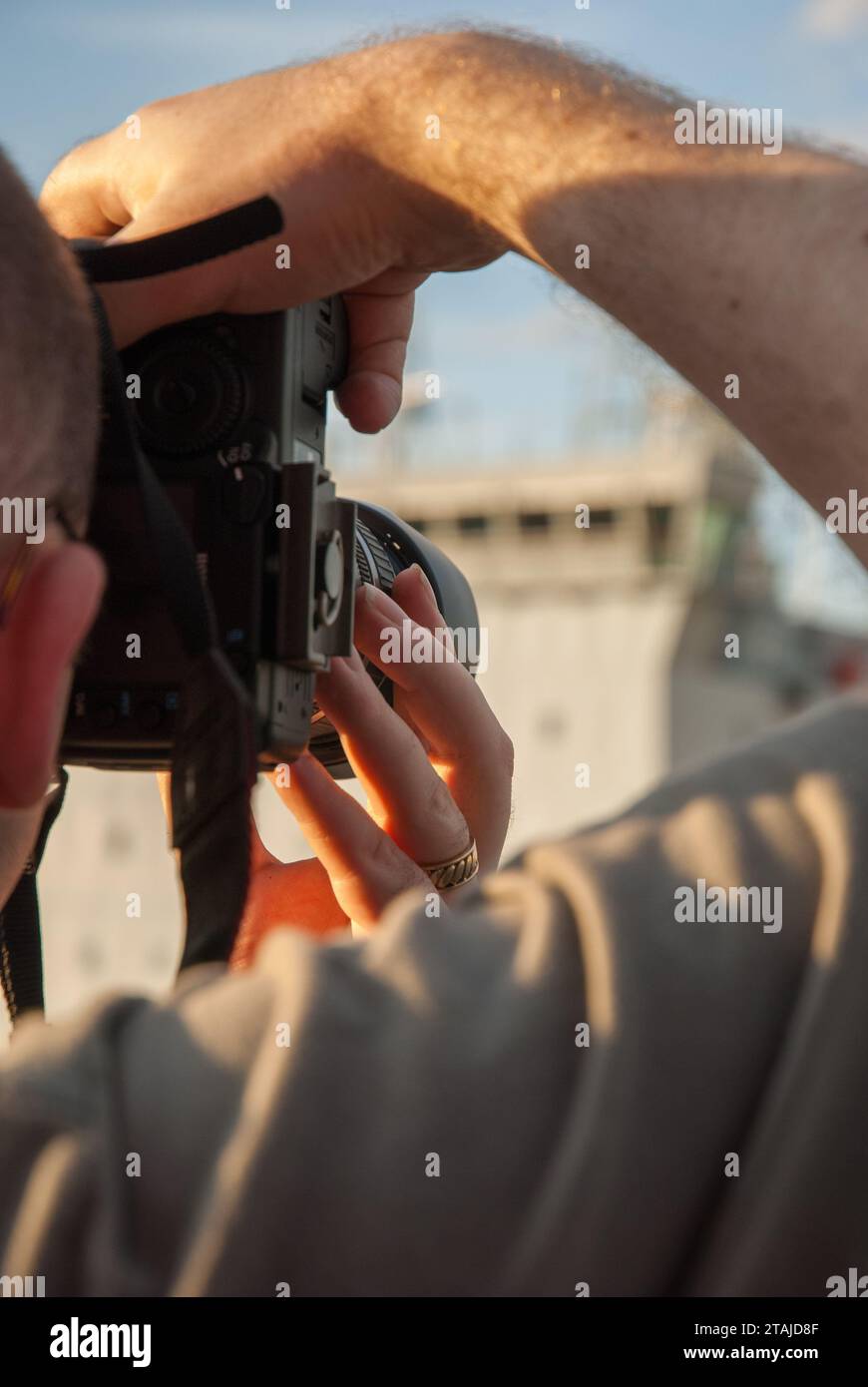 photographer in focus taking a photograph, viewed from over the ...